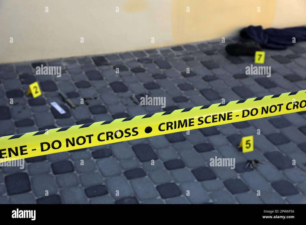 Crime scene tape for covering the area cordon. Yellow tape with blurred ...