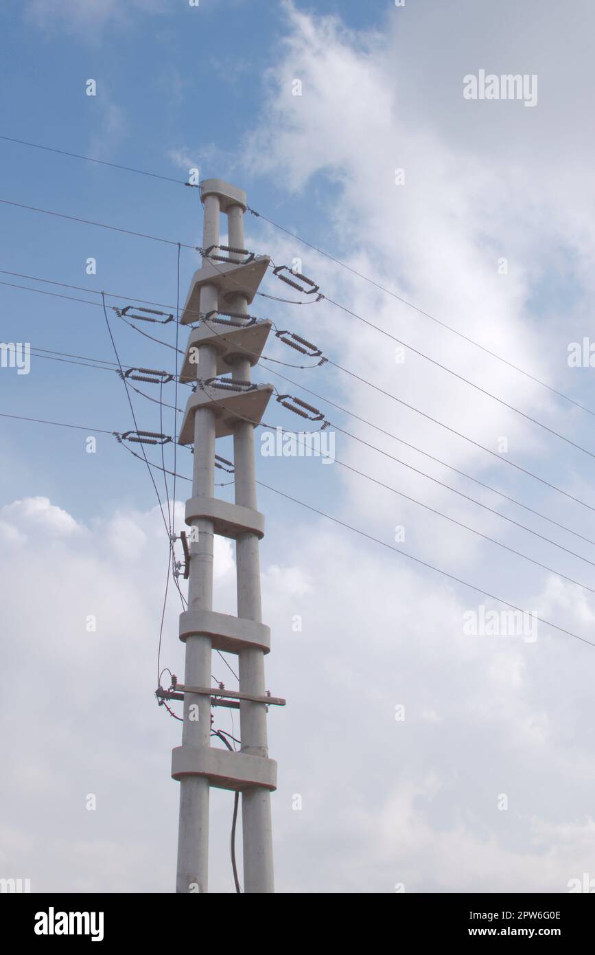 An electrical pylon stands tall against the blue sky. Ceramic ...