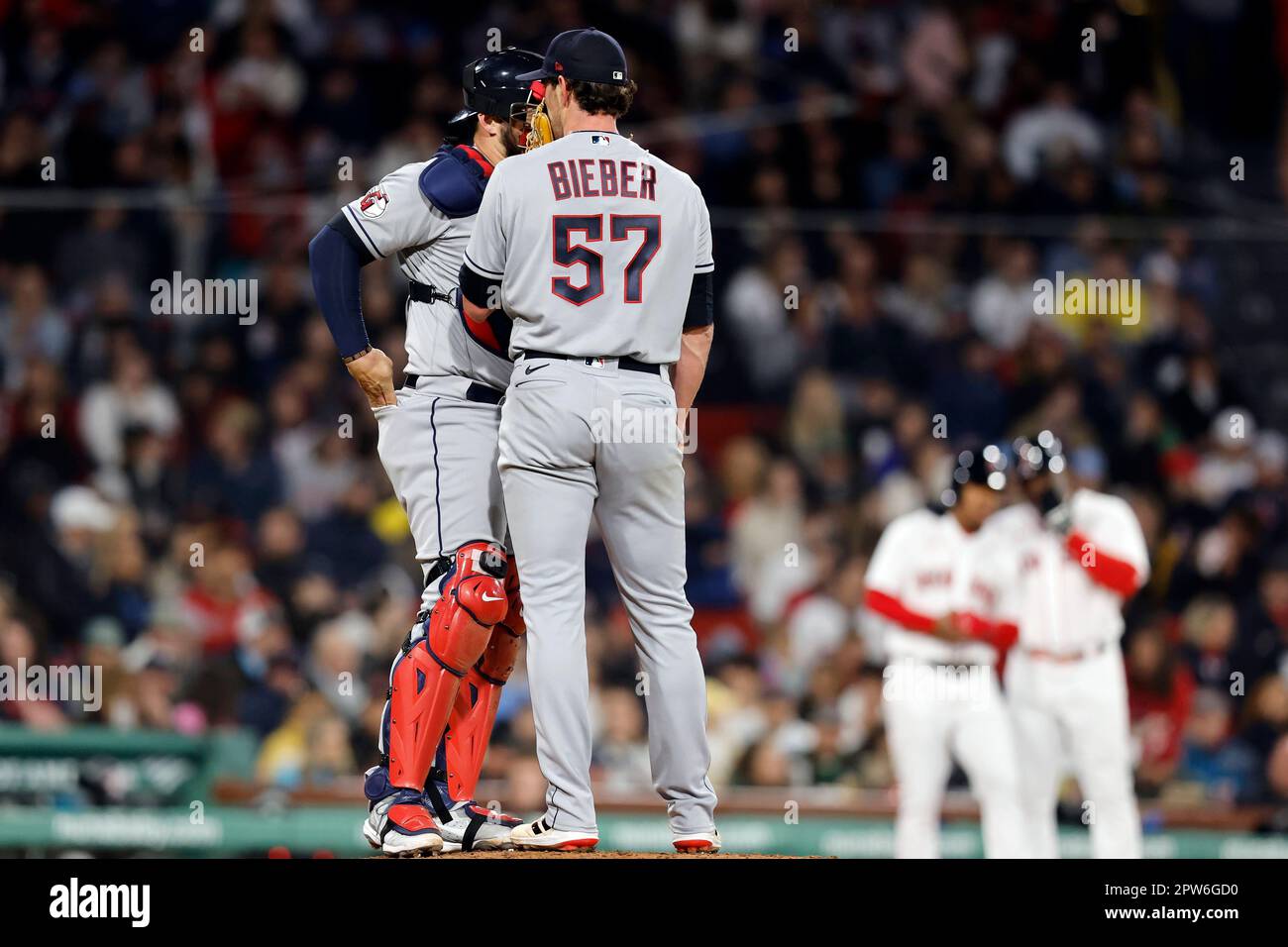 Cleveland Guardians' Mike Zunino confers with Shane Bieber (57) during ...