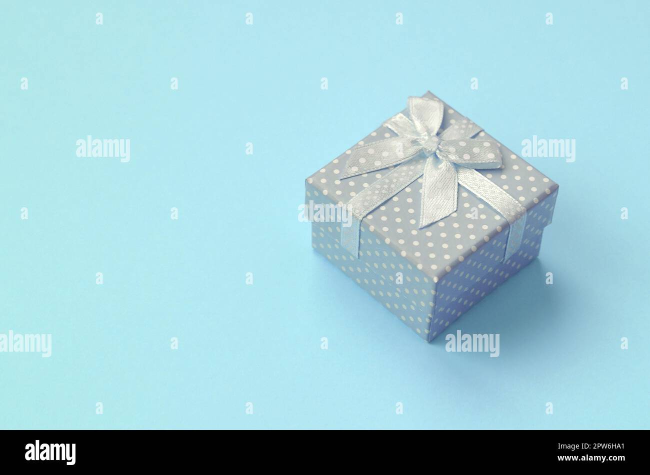 Small blue gift box lie on texture background of fashion pastel blue ...