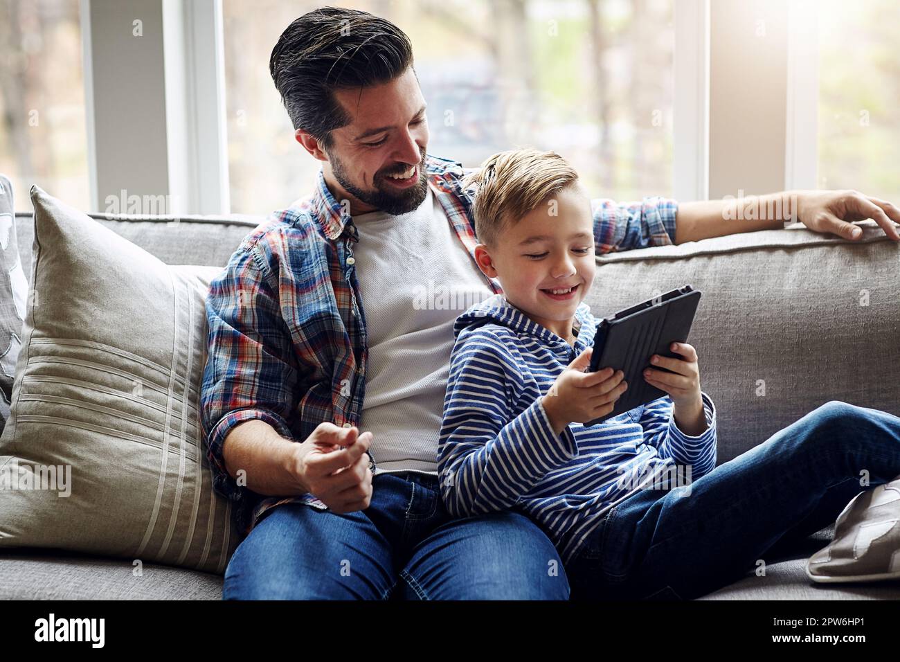 Digital tablets are becoming modern toys. a little boy using a digital ...