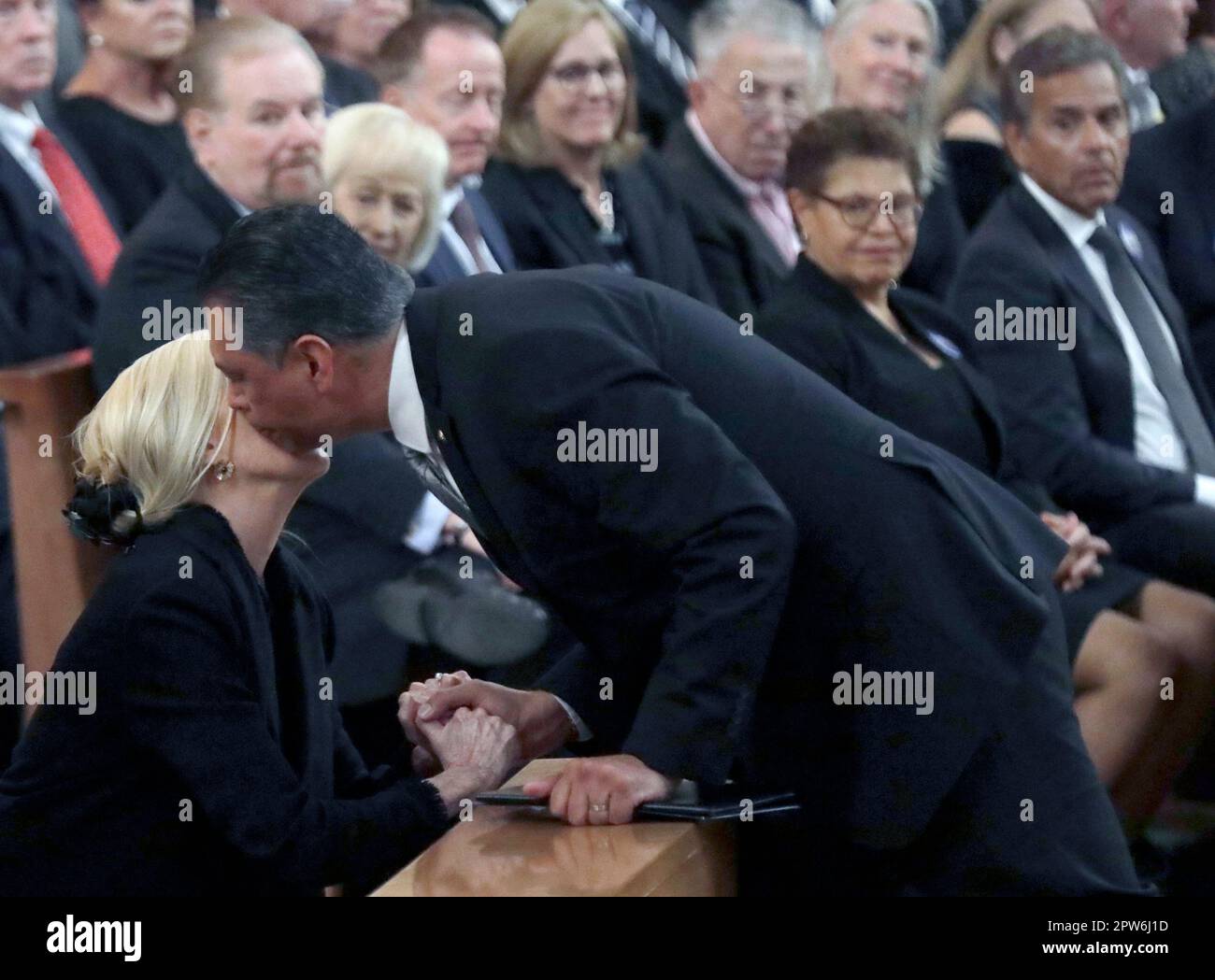 U.S. Senator Alex Padilla gives Elizabeth Riordan, the wife of the ...