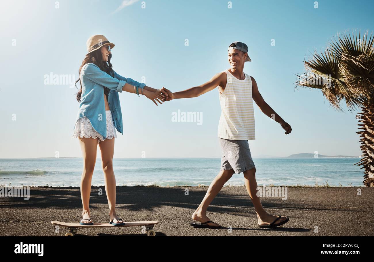 He swept her off her feet and onto a skateboard. a young man teaching ...