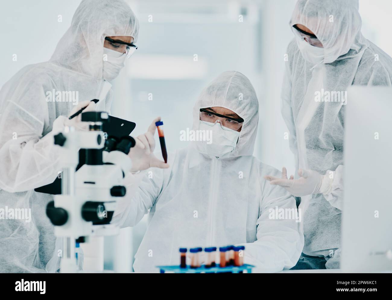 Hazmat suit scientists with test tube in medical research, healthcare ...