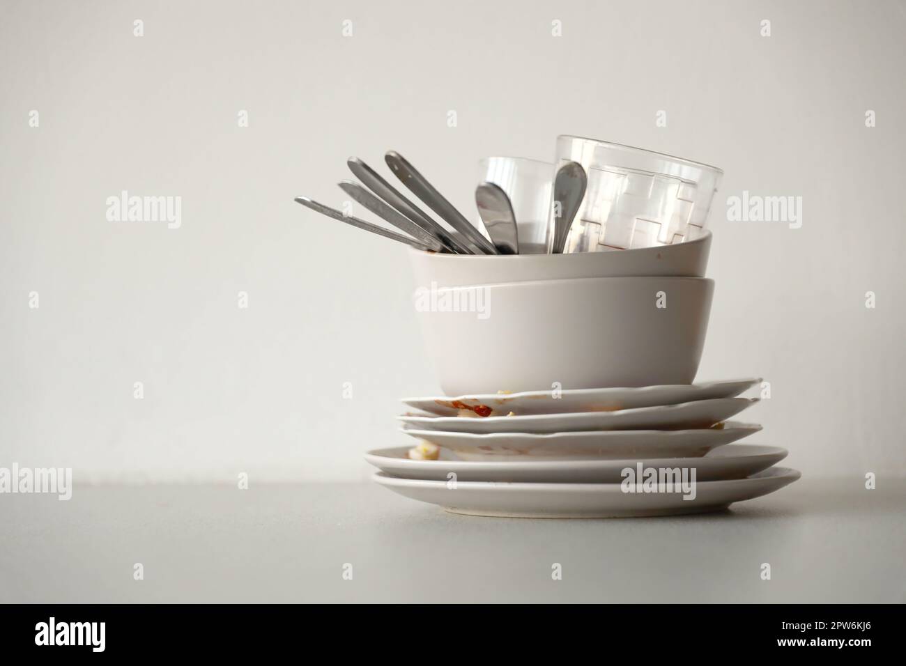 Stack of dirty dishes with food leftovers on the table after meal ...