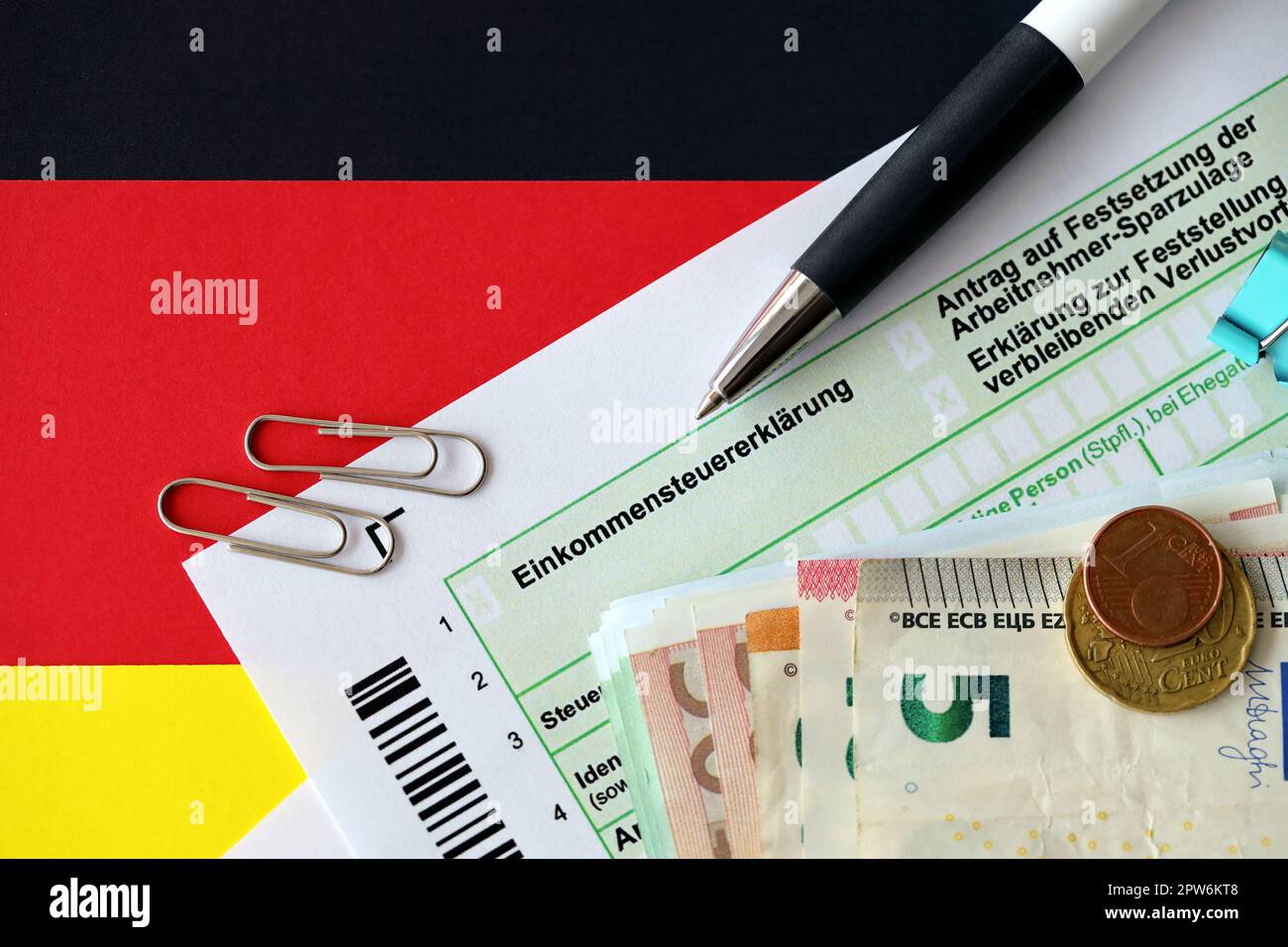 German income tax return form with pen and european euro money bills ...