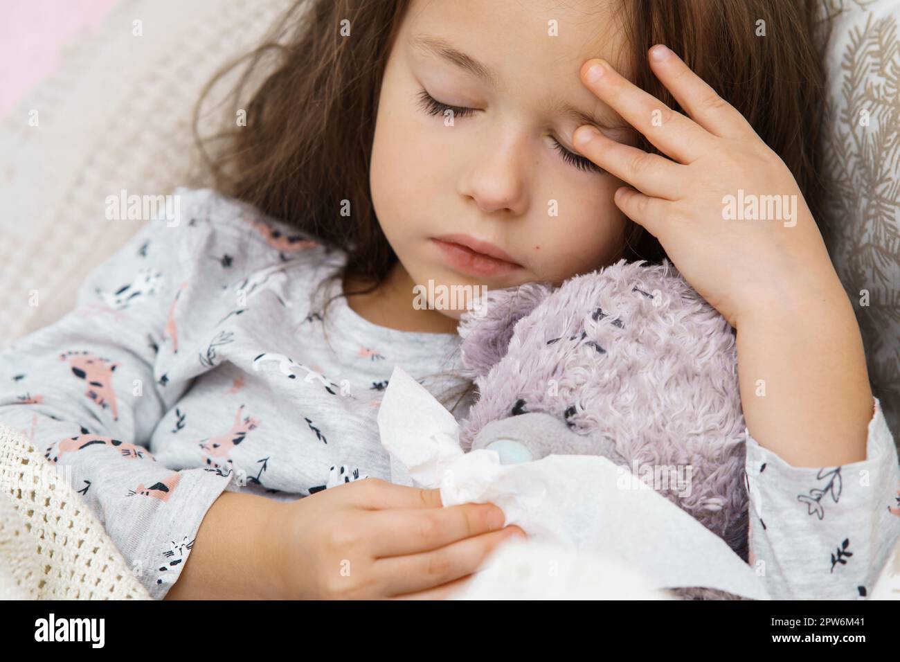 Tired Little Brunette Girl Napping With Close Eyes Touching Head Wiping Imaginary Snot Of Bear