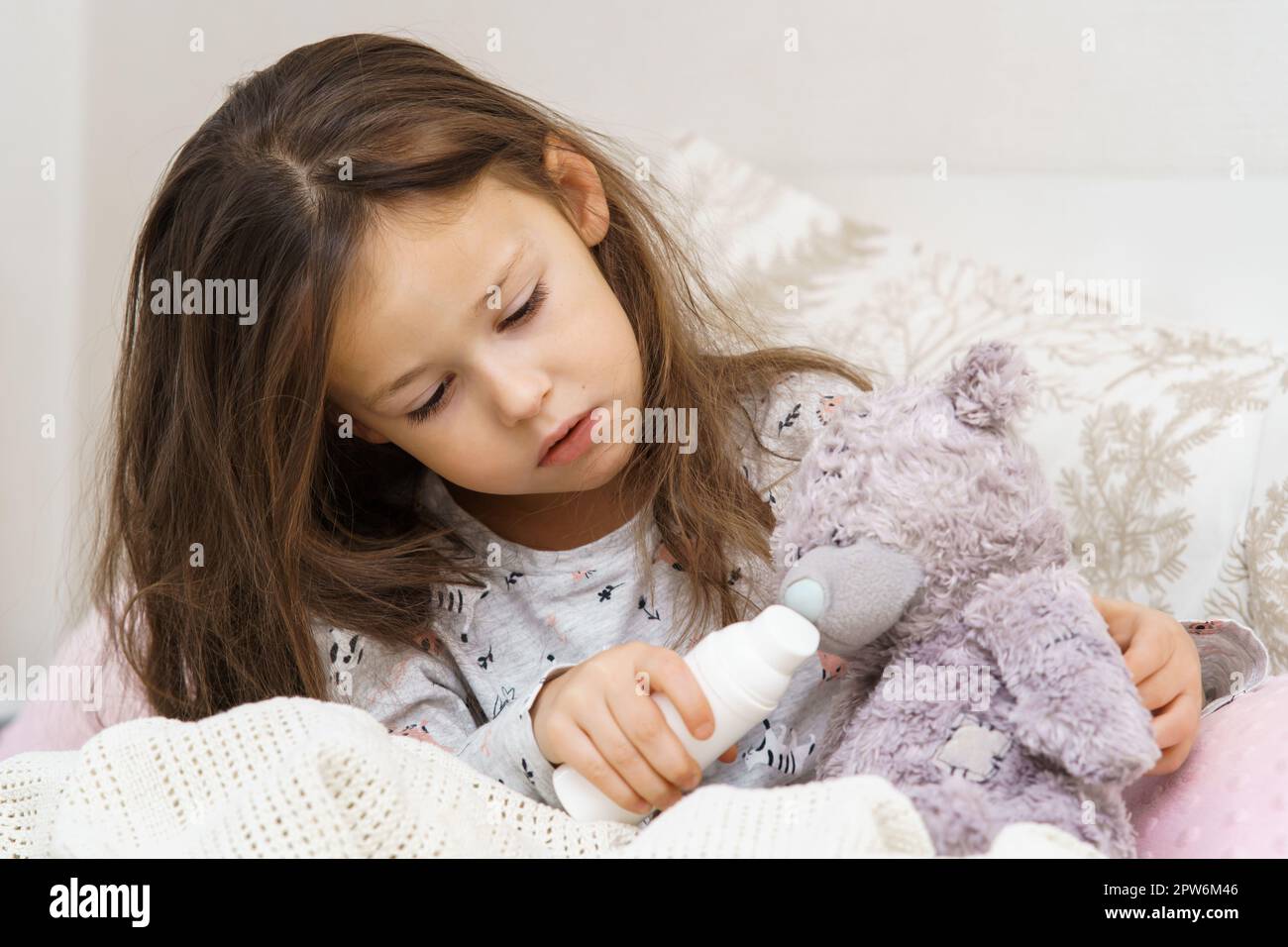 Worried, sunless, tired little brunette girl embracing bear toy patient ...
