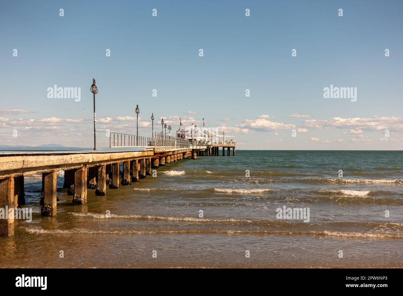 Jetty on the beach in warm sunlight Stock Photo - Alamy