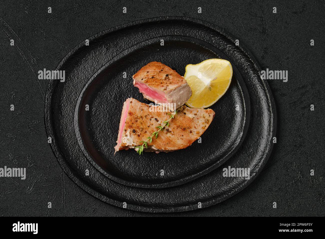 Top view of roasted tuna steak in a slate plate Stock Photo - Alamy