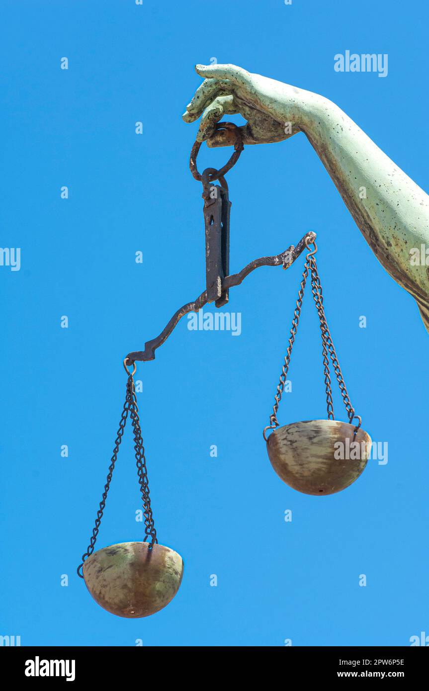 Close up of a scale with weighing bowls in a metal hand Stock Photo - Alamy