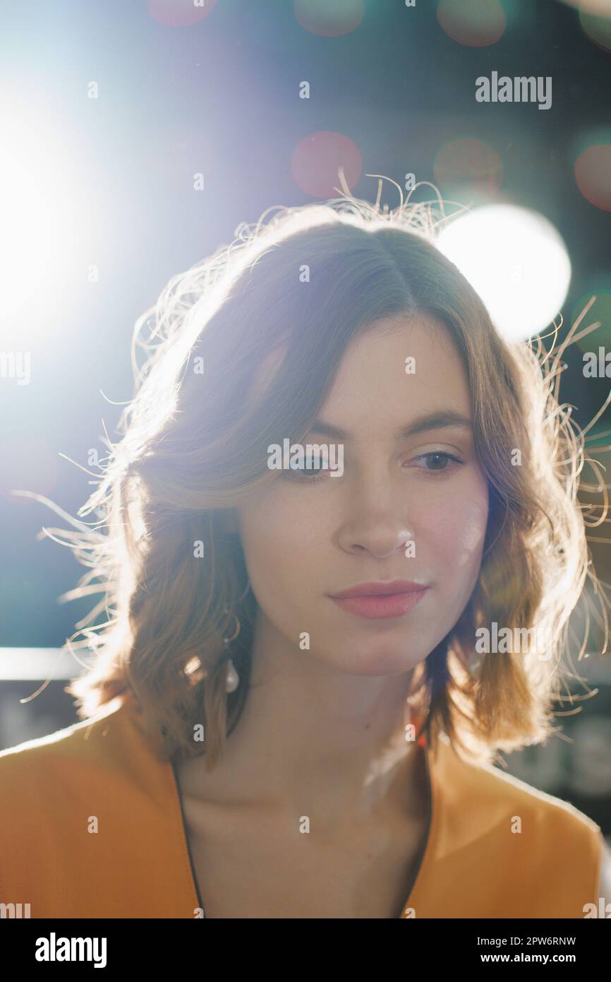 Portrait of dreamy pretty girl in yellow vest with natural makeup with ...
