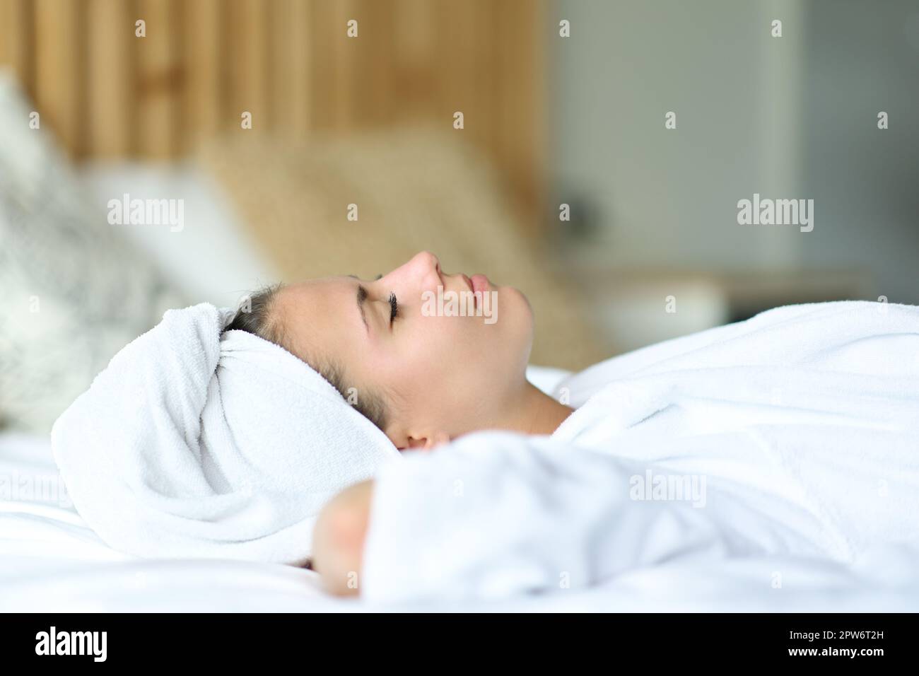 Teen resting and relaxing after showering lying on the bed Stock Photo ...