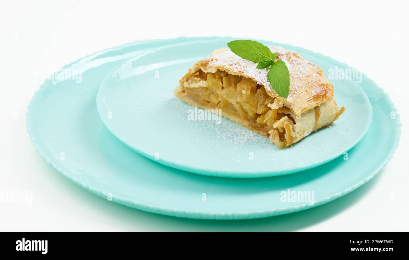 Slice of apple strudel on a round plate, white background Stock Photo ...
