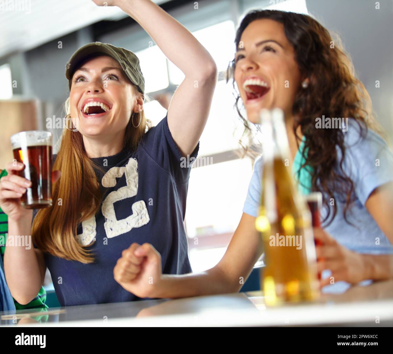 What would she do without drinks and sport. Two girl friends cheering ...