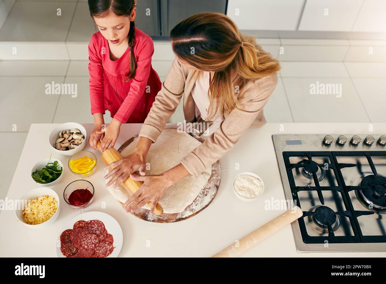 Pizza is everyones favorite. High angle shot of a middle aged mother ...