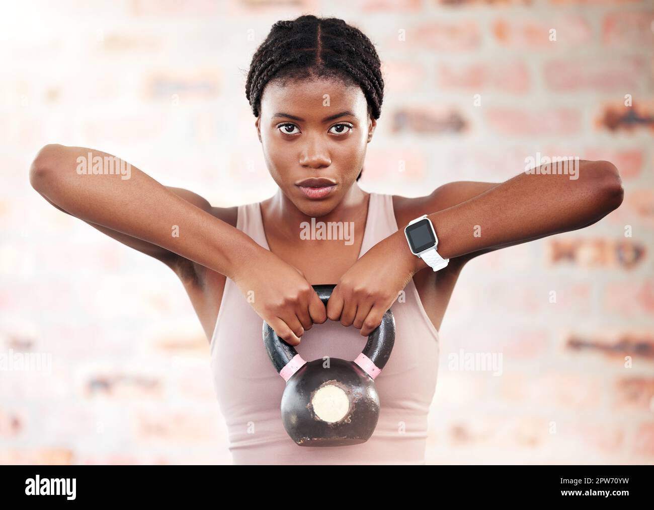 Black woman, fitness and kettlebell with focus and exercise in gym ...