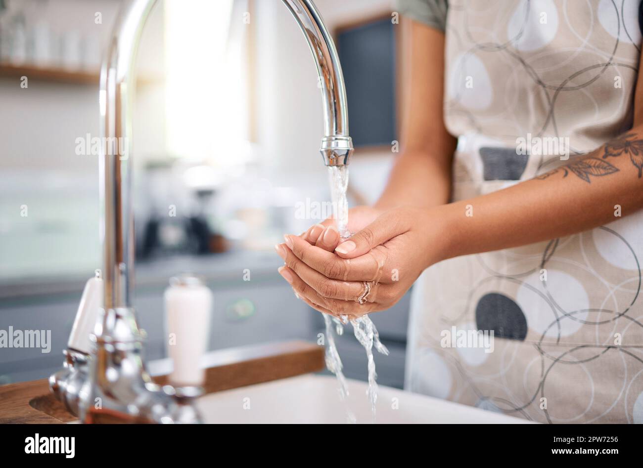Close up of woman washing her hands in sink with tap water in the ...