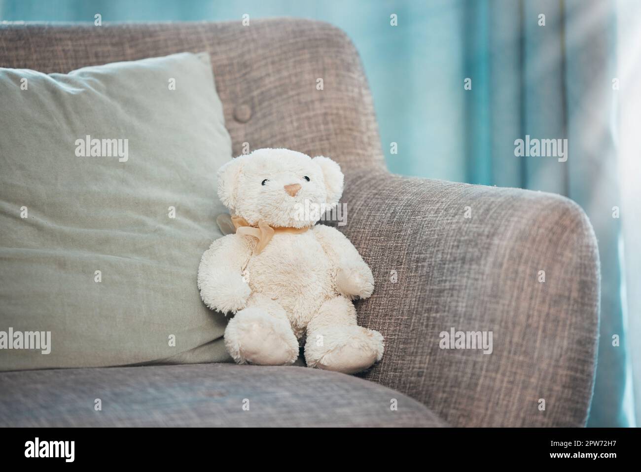 Lonely, loss and adoption with a teddy bear abandoned on a sofa in an ...