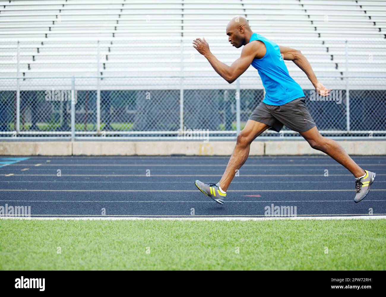 Hes got grace and speed. Full length side view of a male runner running ...