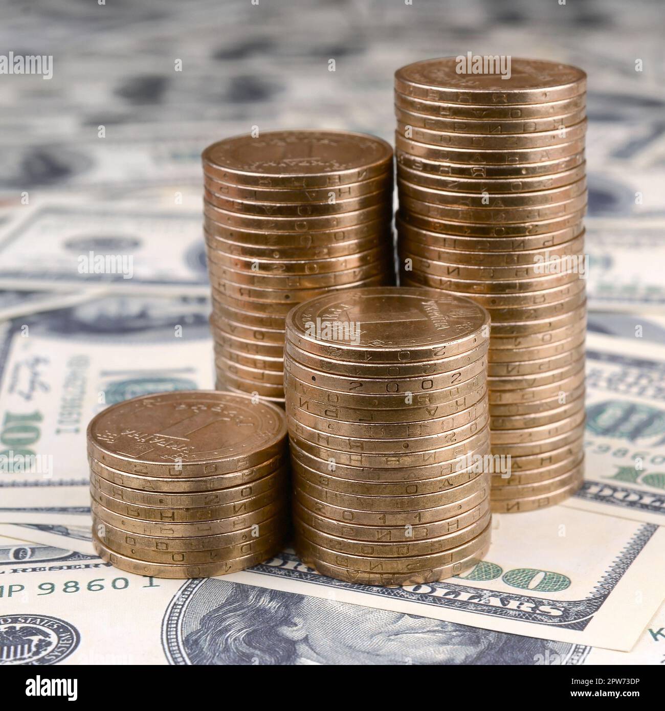 Stack of ukrainian coins in rising stacks grow up. Ukrainian money lies ...