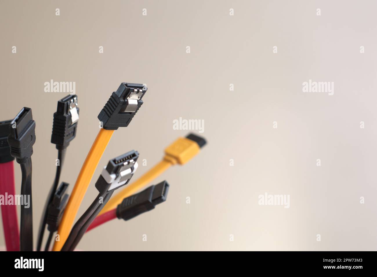 Red, black and yellow data cables on white background. Data storage ...