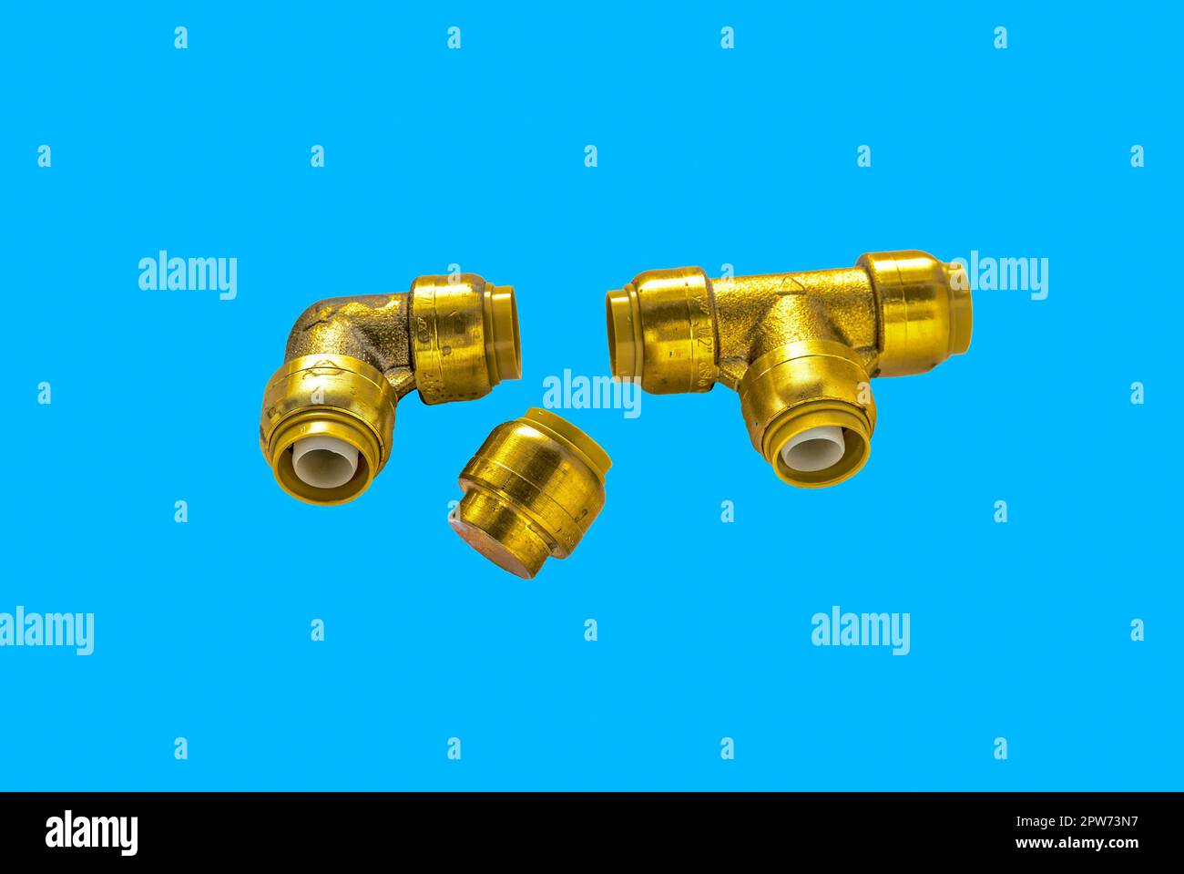 Bronze angle fittings for water connection shot on a blue background ...