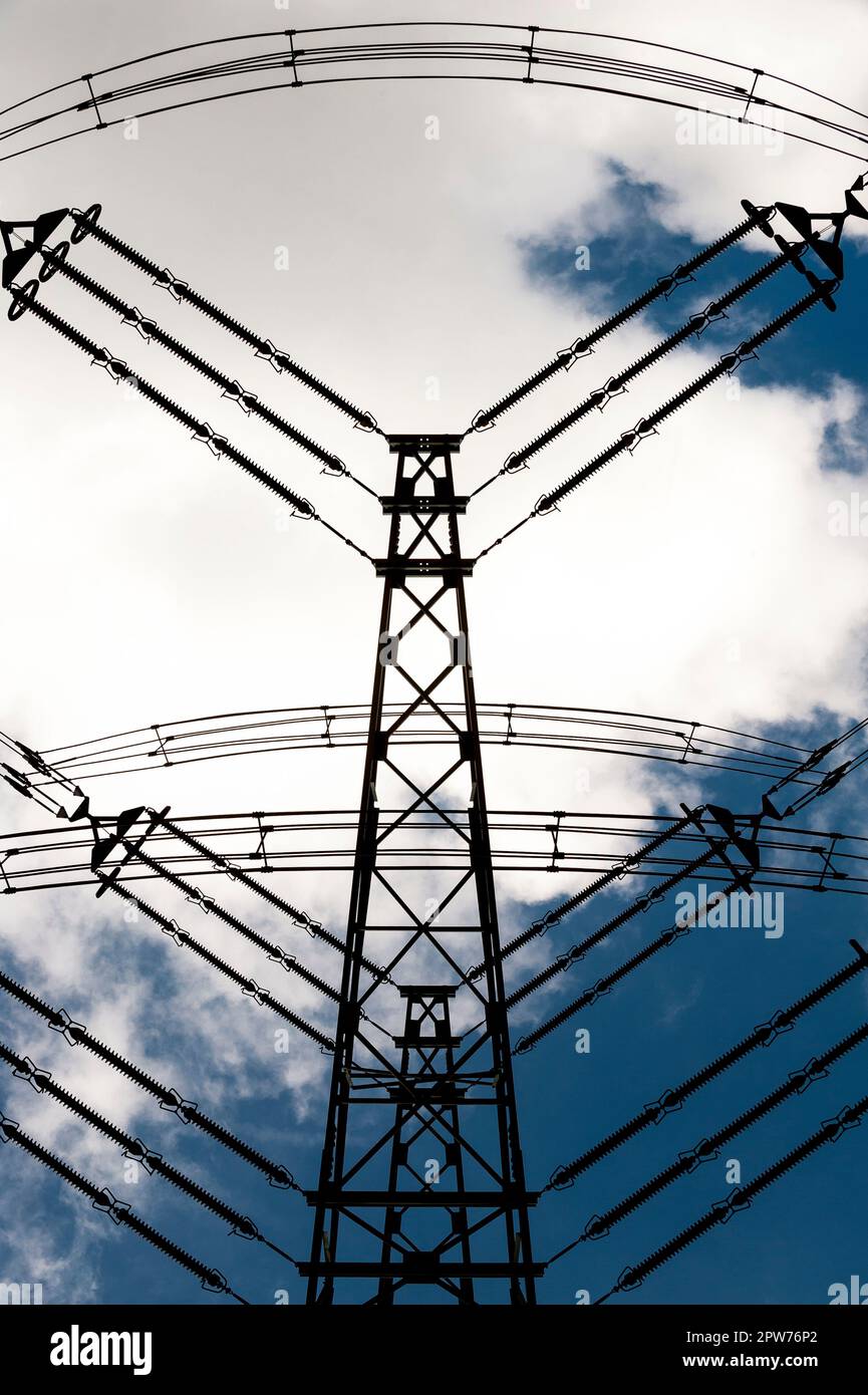 Power pole, cables and insulators of a high-voltage line in bottom view ...