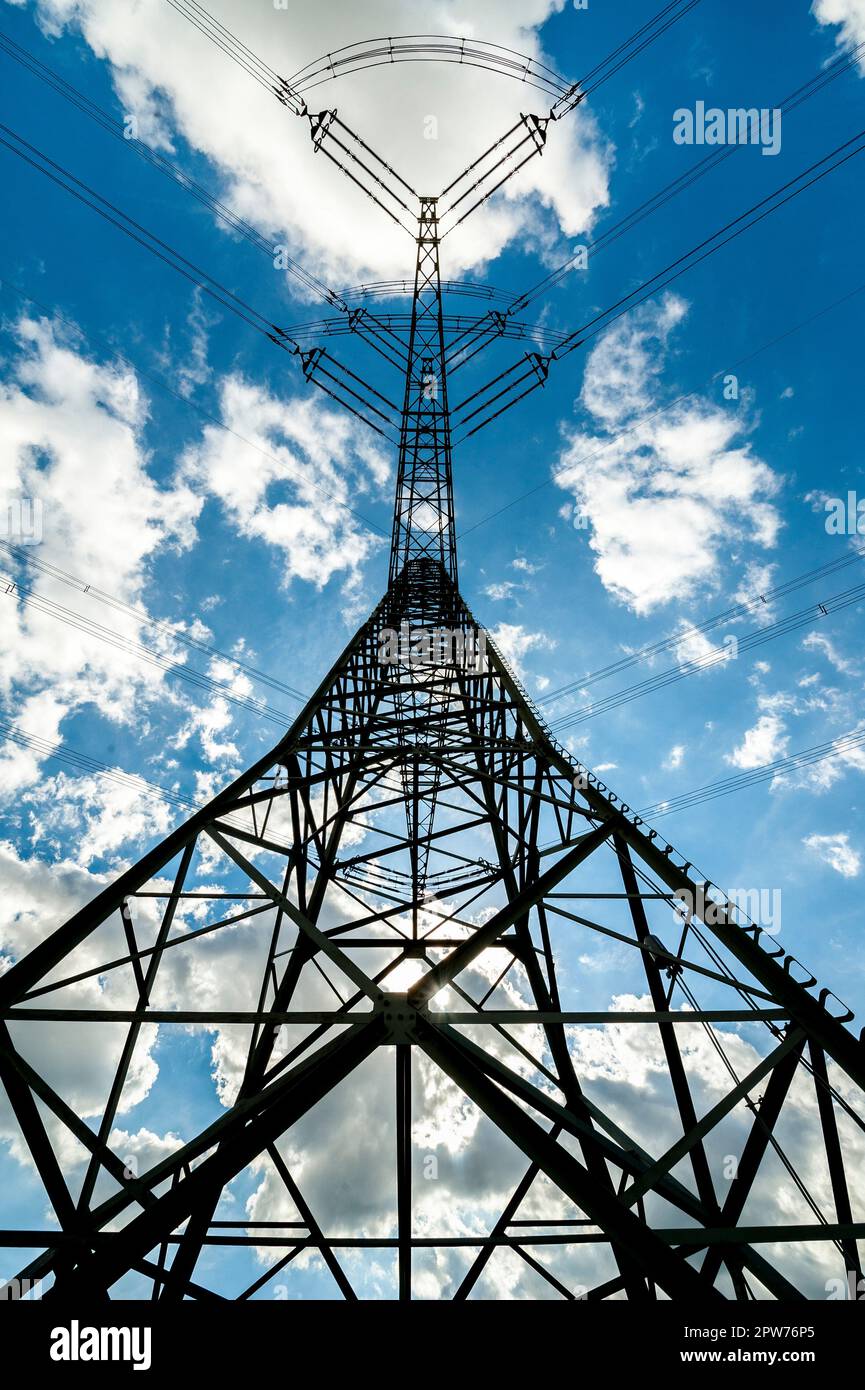 Power pole, cables and insulators of a high-voltage line in bottom view ...