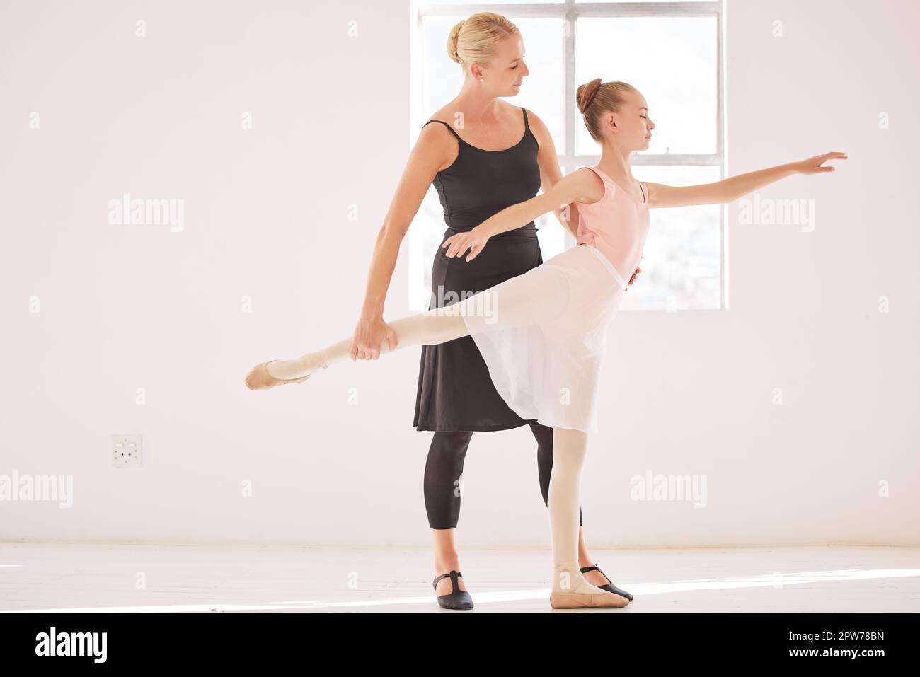 Ballet teacher teaching a student in a dance class or studio at an art ...