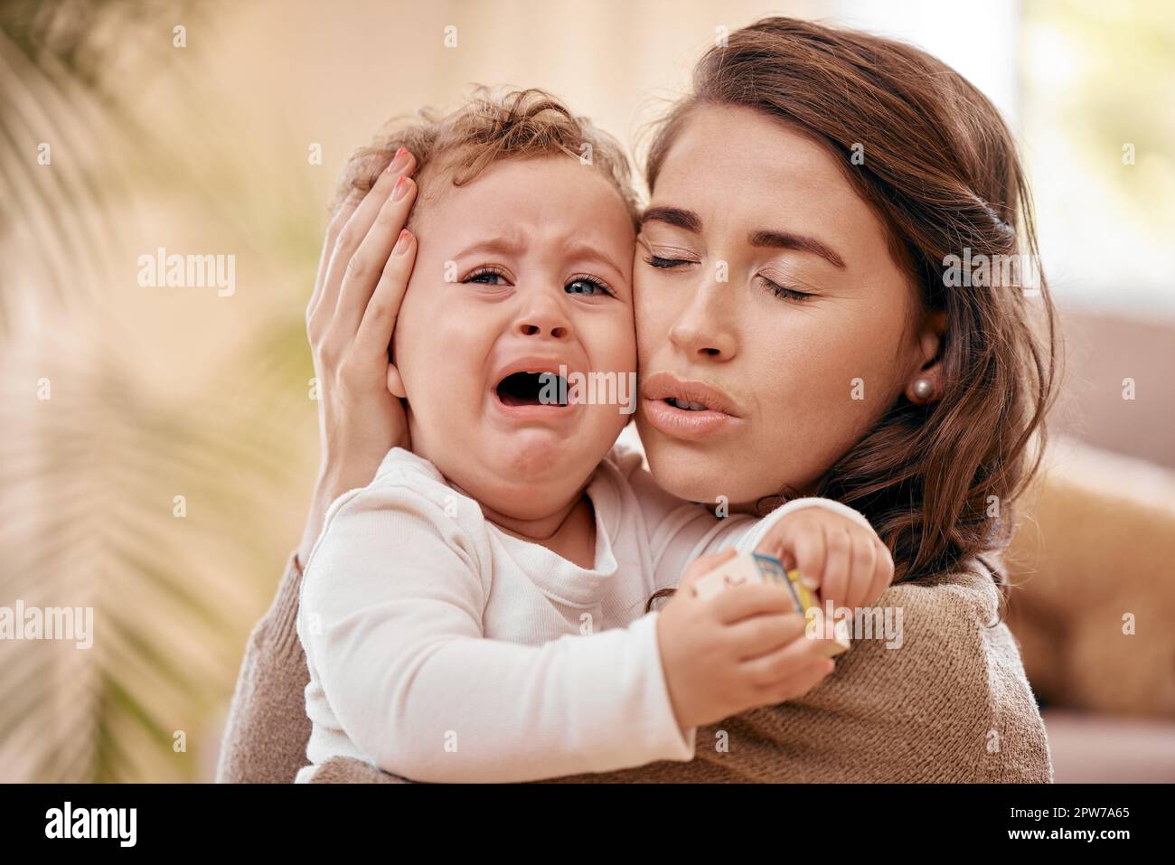 Mother comforting crying infant hi-res stock photography and images - Alamy
