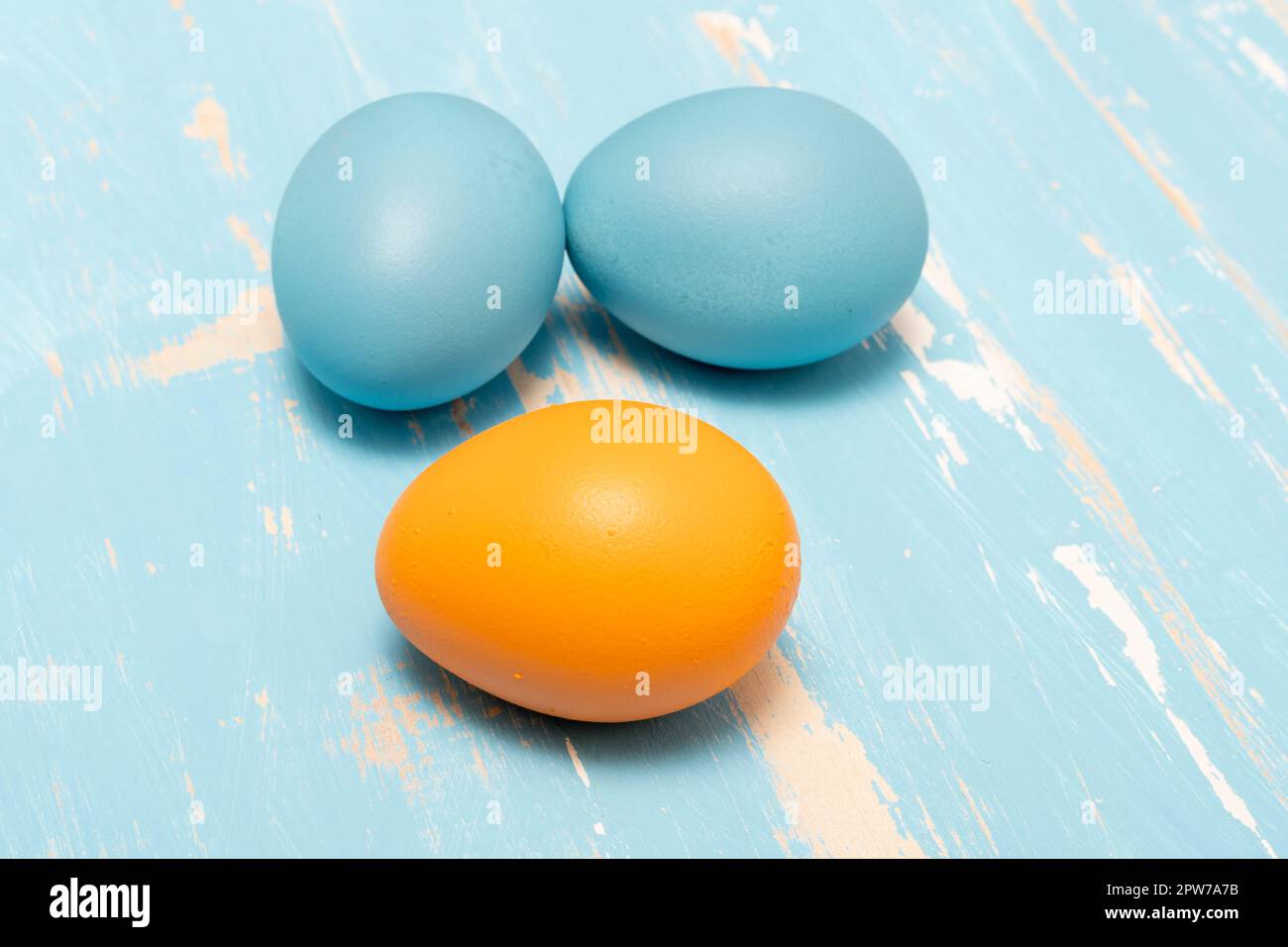 Eggs symbolizing the Easter holiday in blue and orange color on a ...