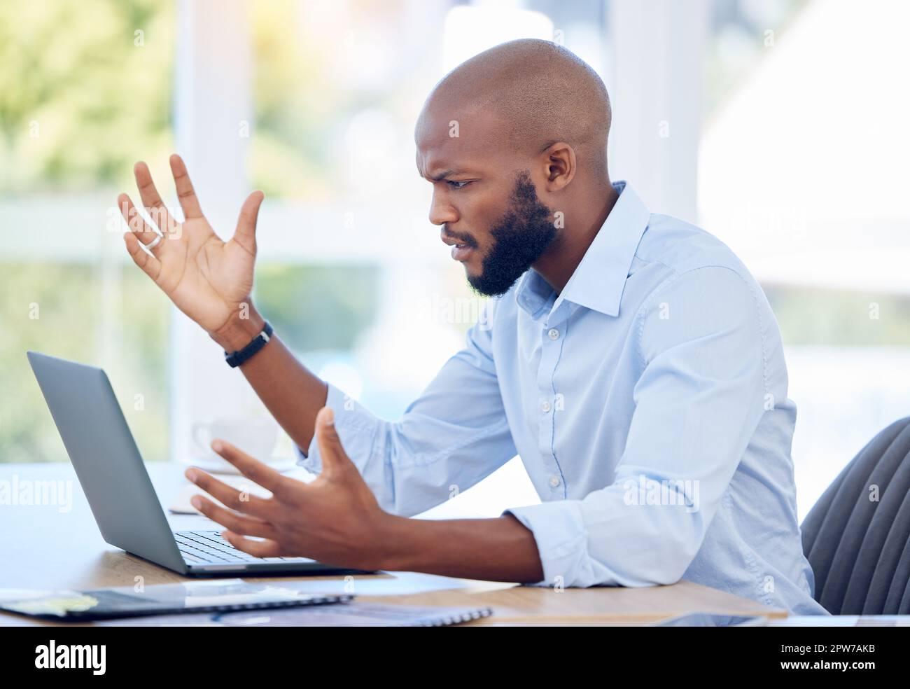 What is this. a young businessman looking confused while working in an ...