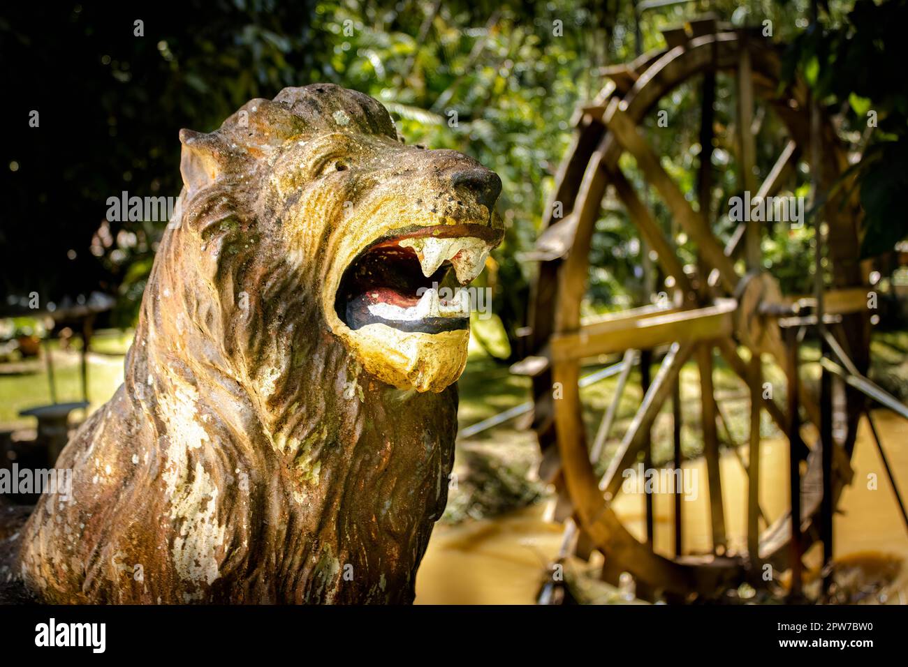 Lion sculpture next to the water wheel at the zoo in Marechal Floriano ...