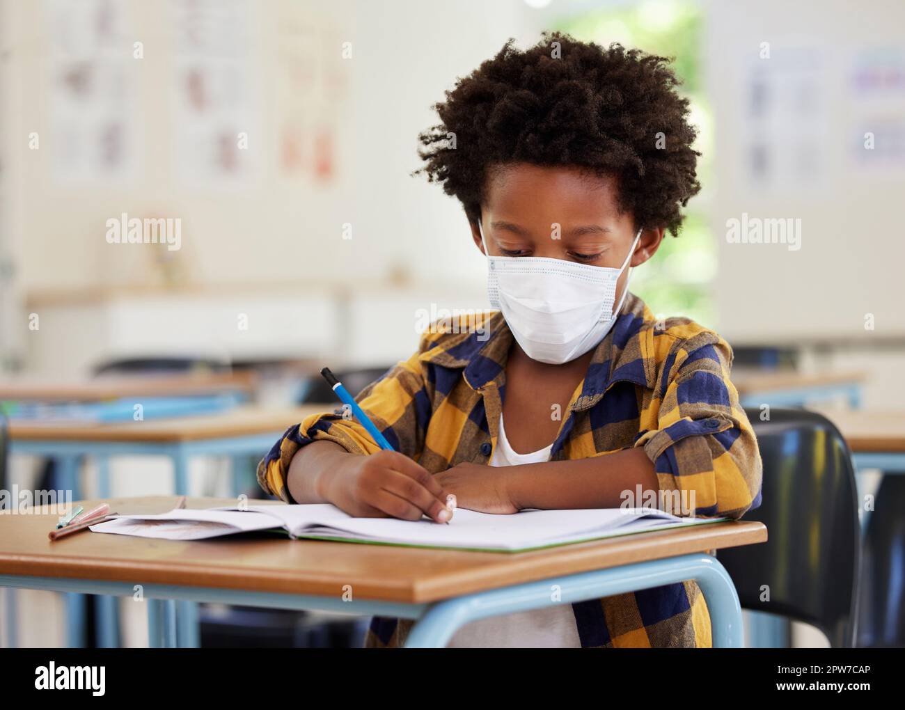 School boy, student and learning while writing and working in his book ...