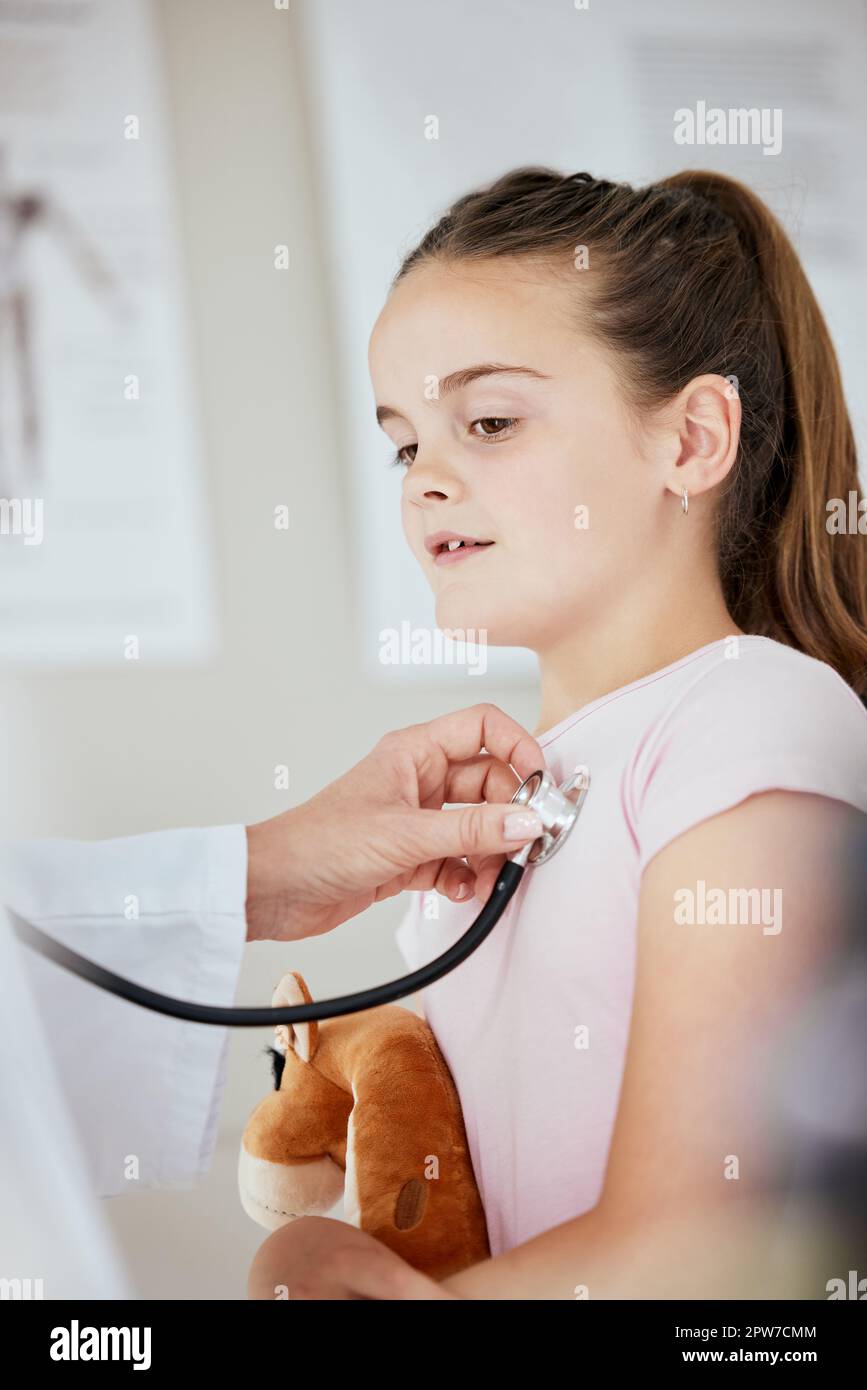 Annual checkups are important. a little girl getting a checkup at a ...