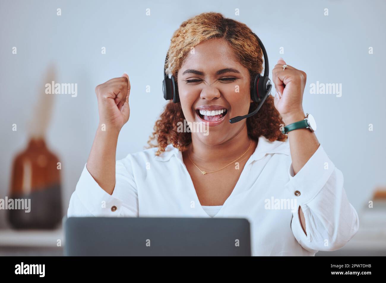Young happy and excited mixed race businesswoman cheering in support ...
