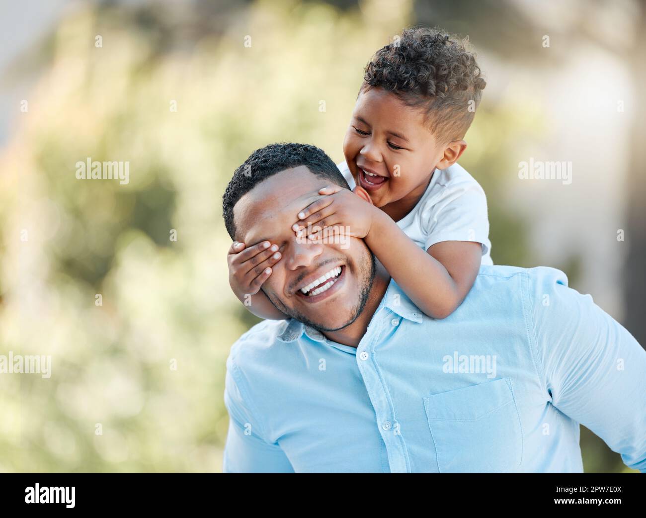 Were having lots of fun. a little boy covering his fathers eyes while ...