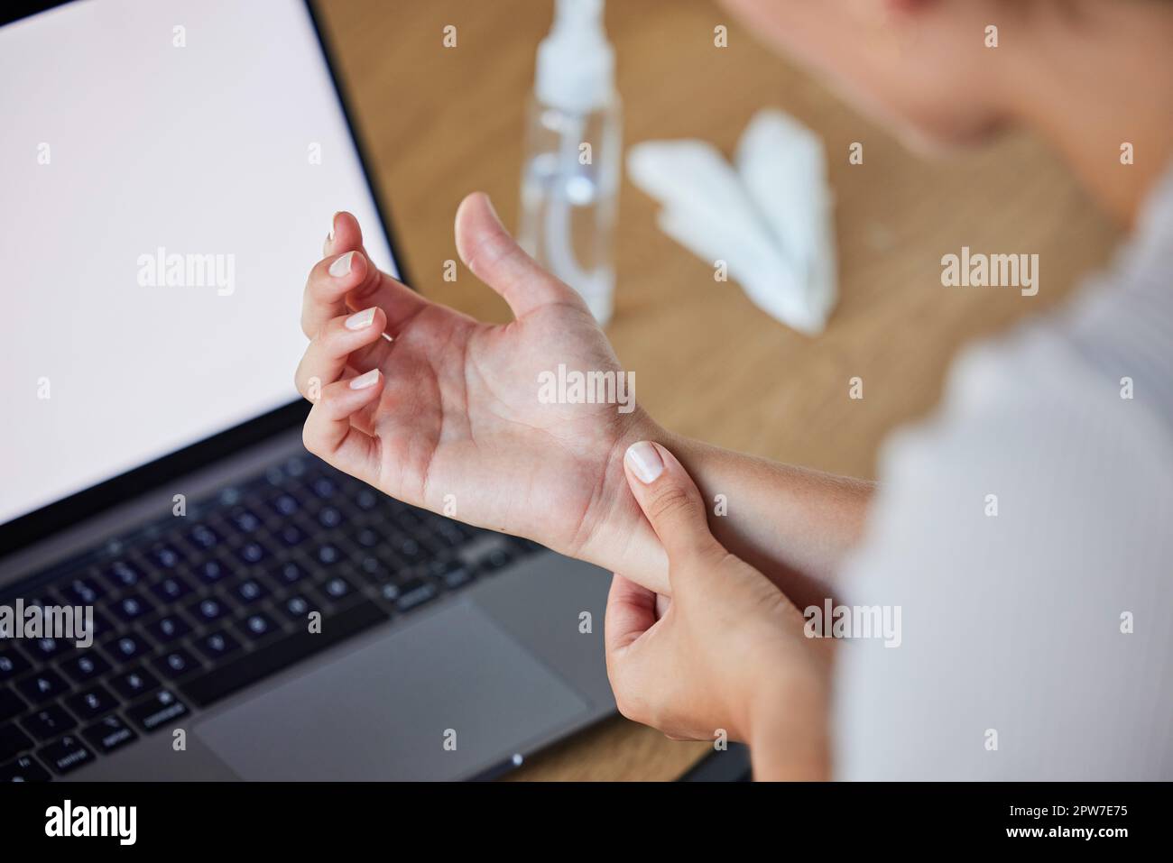 Wrist, pain and woman at laptop working with injury, arthritis or ...