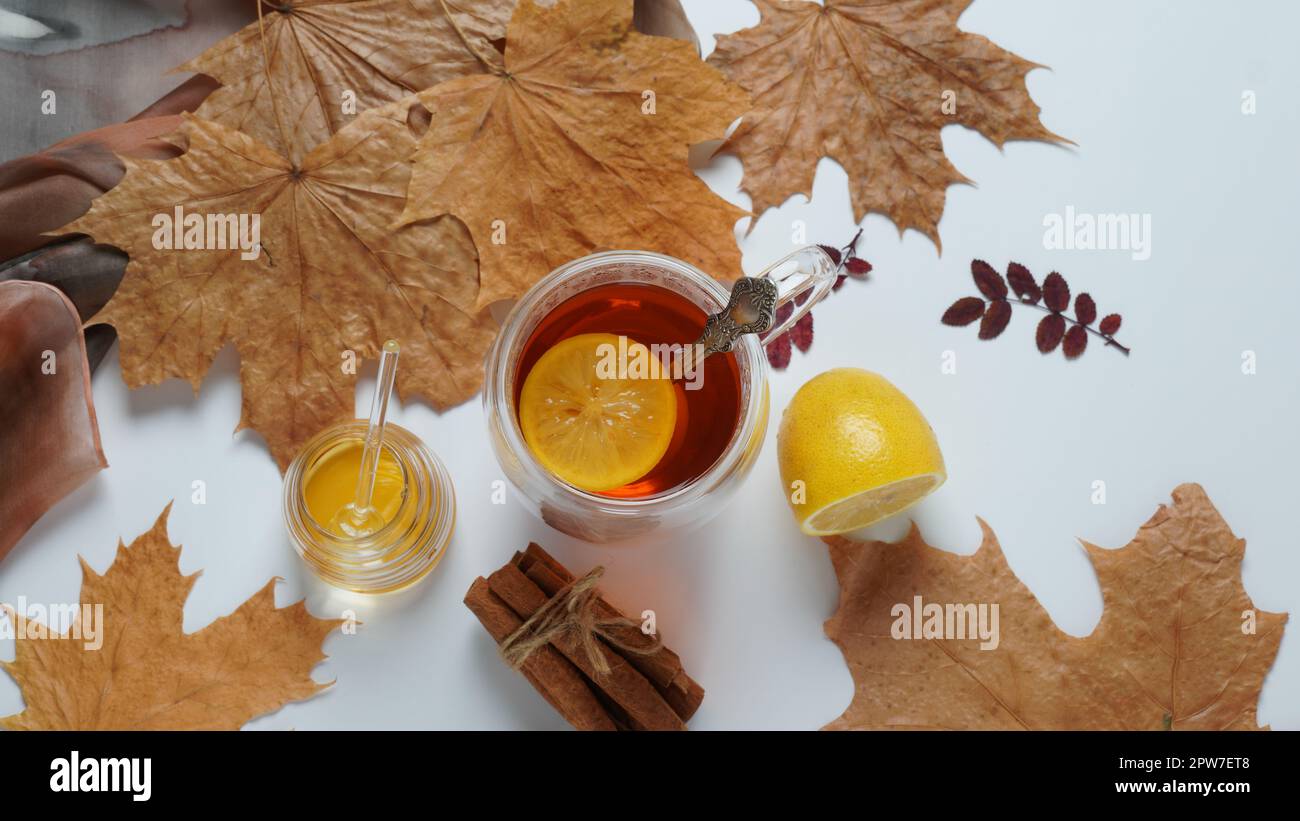 Autumn hot tea with cinnamon sticks and lemon in transparent cup Stock ...