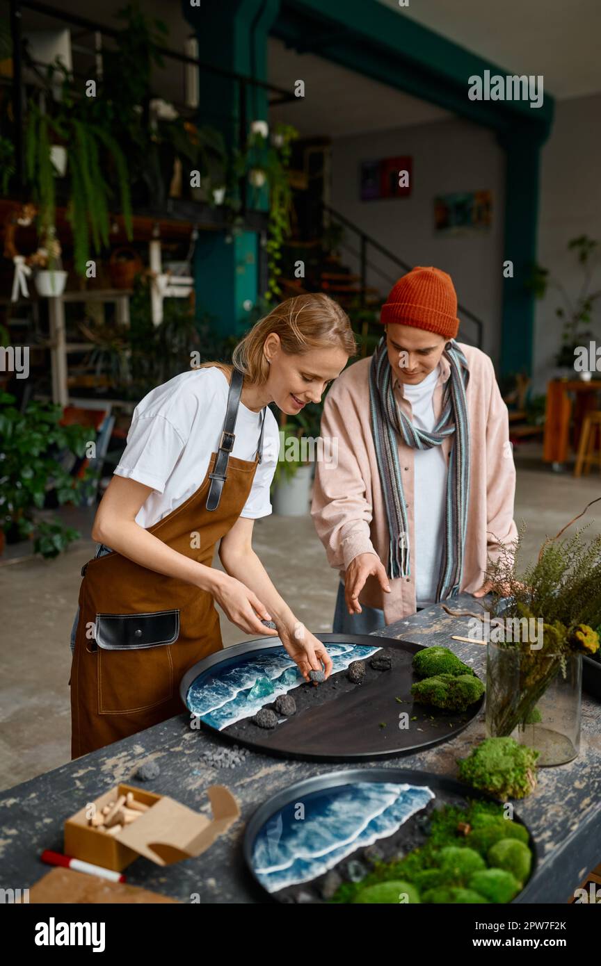Floristic workshop. Two young decorators making composition from ...