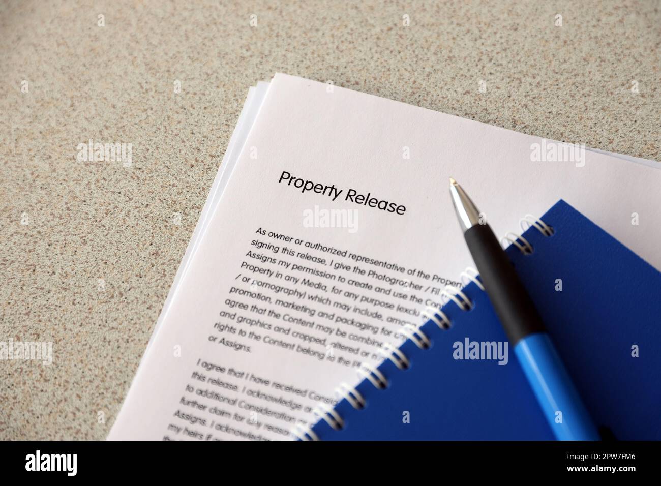 Property release blank form with blue notepad and blue pen lies on ...