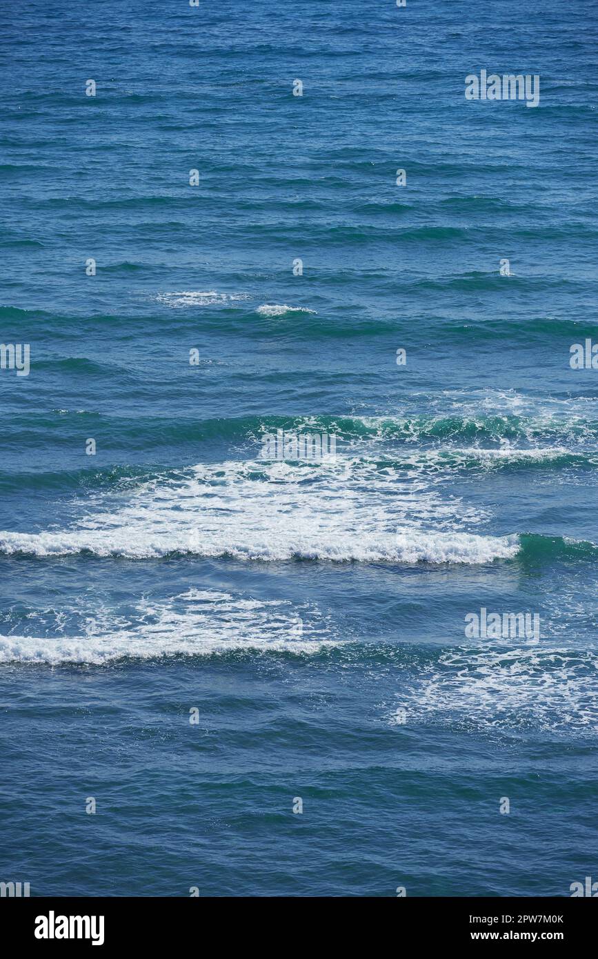 Calm waves in the empty ocean on a sunny day. Beautiful sea water with ...