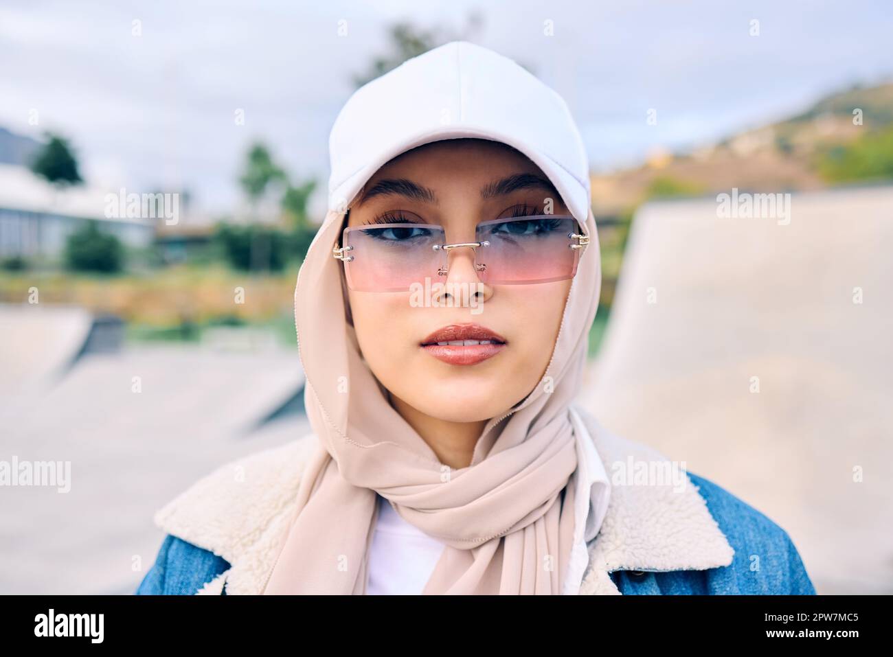 Beautiful young arab woman posing outdoors in a headscarf. Attractive ...
