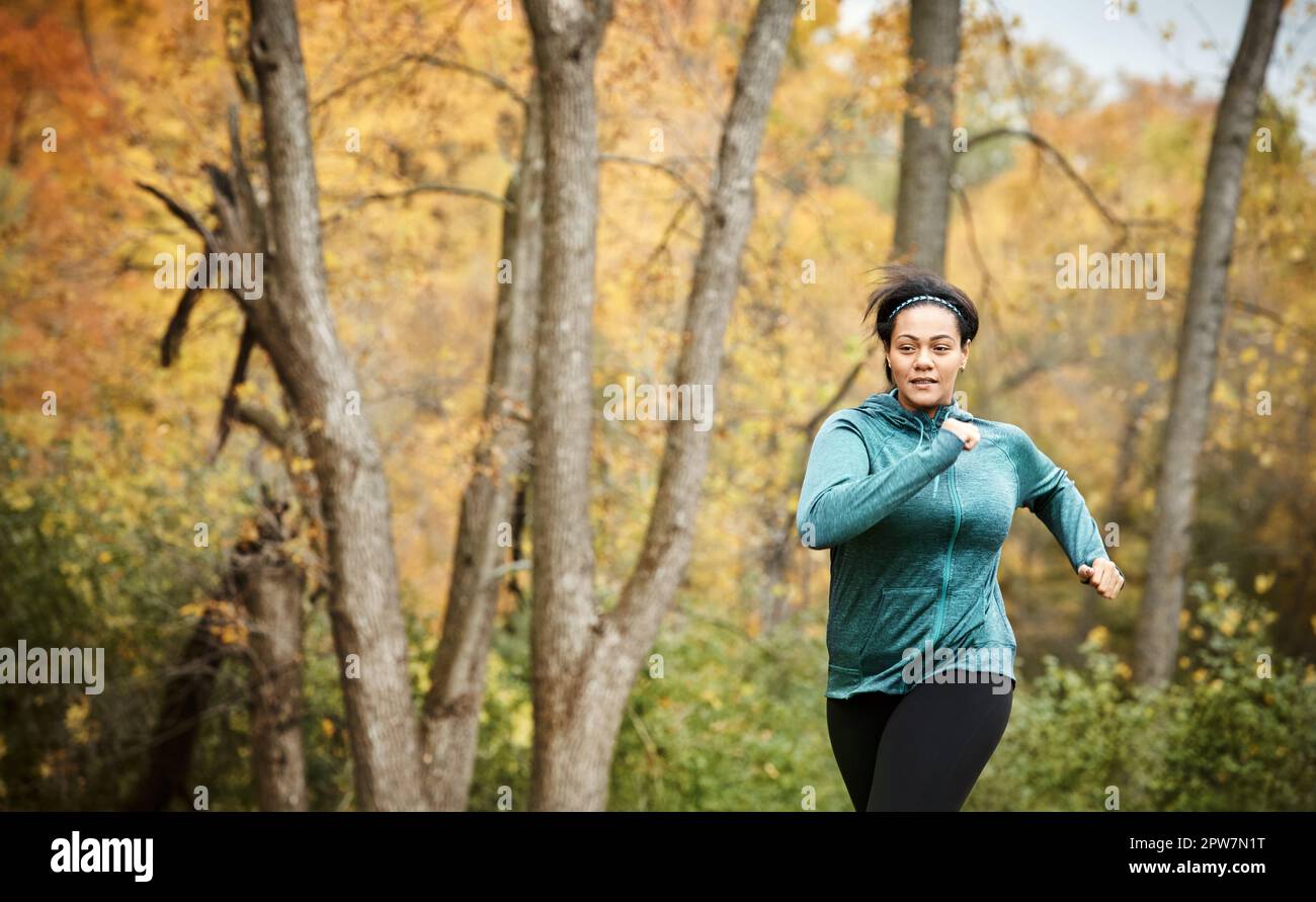 Do it for a healthier you. an attractive young woman going for a run in ...
