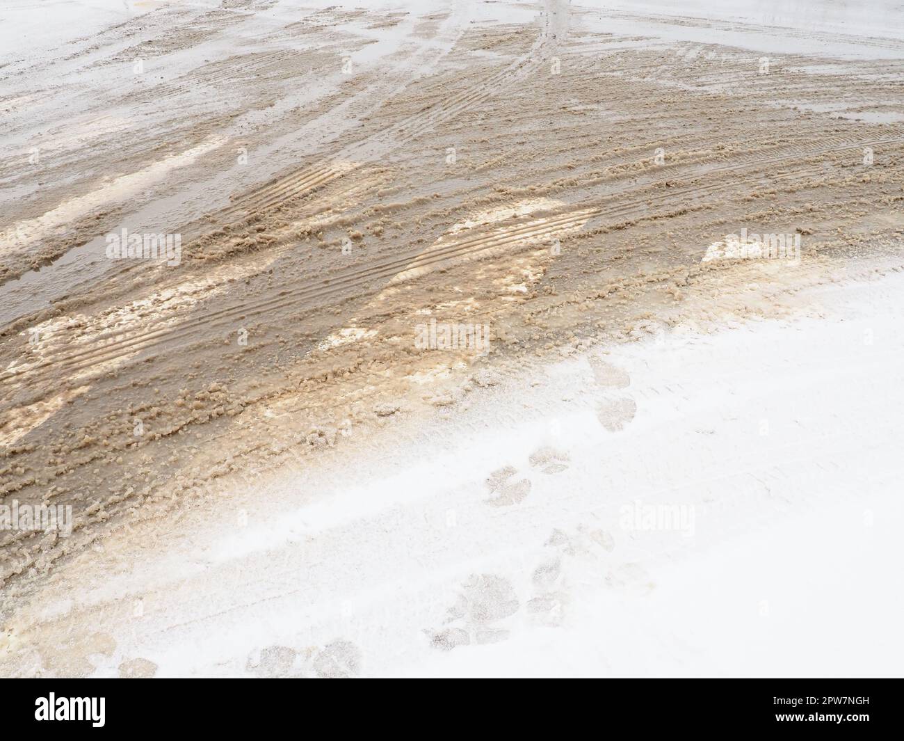 Snow, ice, slush and winter mud at a pedestrian crossing. The air ...