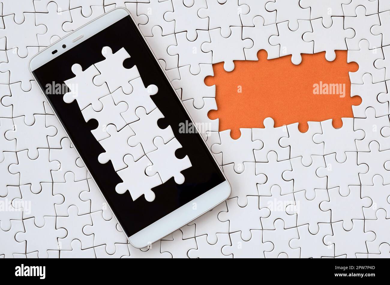 A modern big smartphone with several puzzle elements on the touch ...