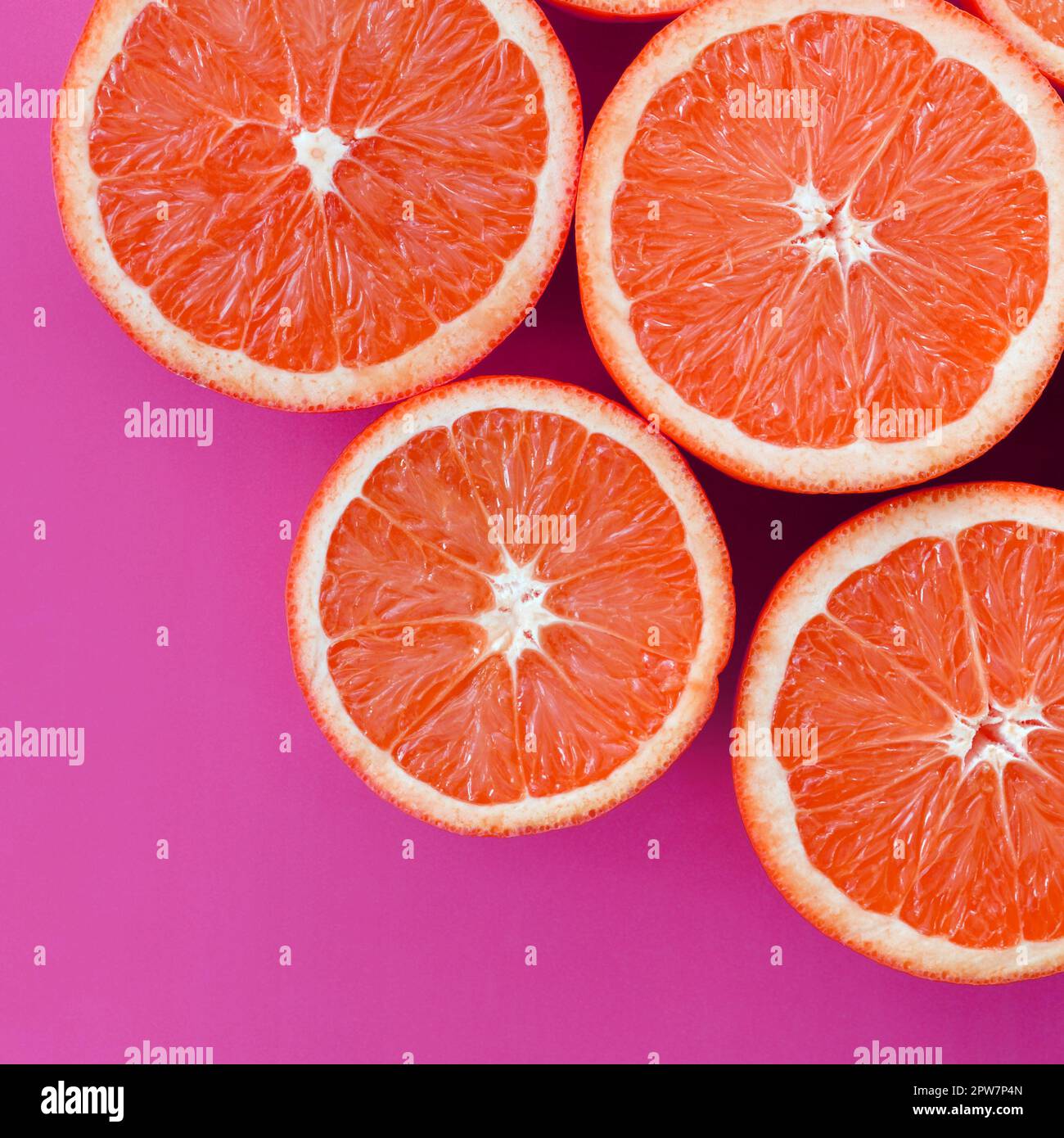 Top view of a several grapefruit slices on bright background in purple ...