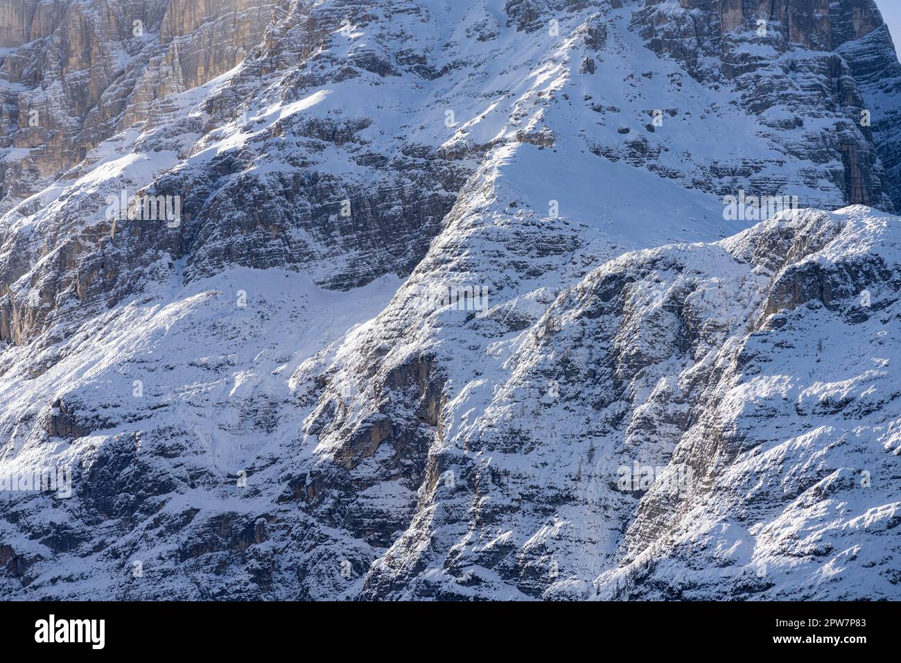 snow and ice deposited on the rock face of a mountain in winter Stock ...