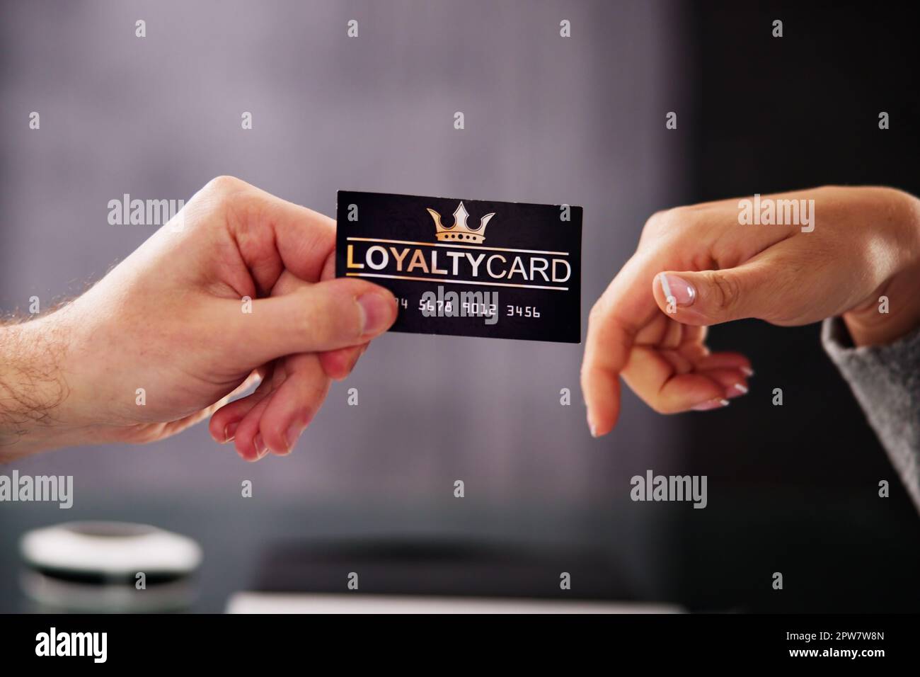 Businessman's Hand Giving Loyalty Card To His Partner Stock Photo - Alamy